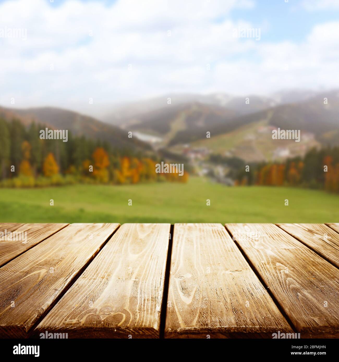 Wooden table on blurred nature background Stock Photo - Alamy