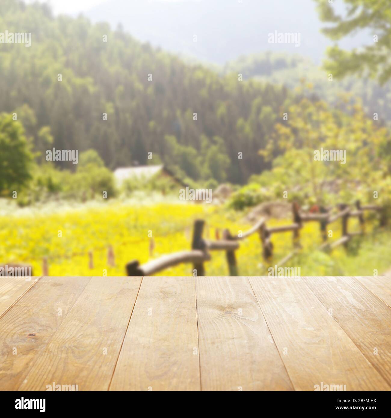 Wooden table on blurred nature background Stock Photo - Alamy