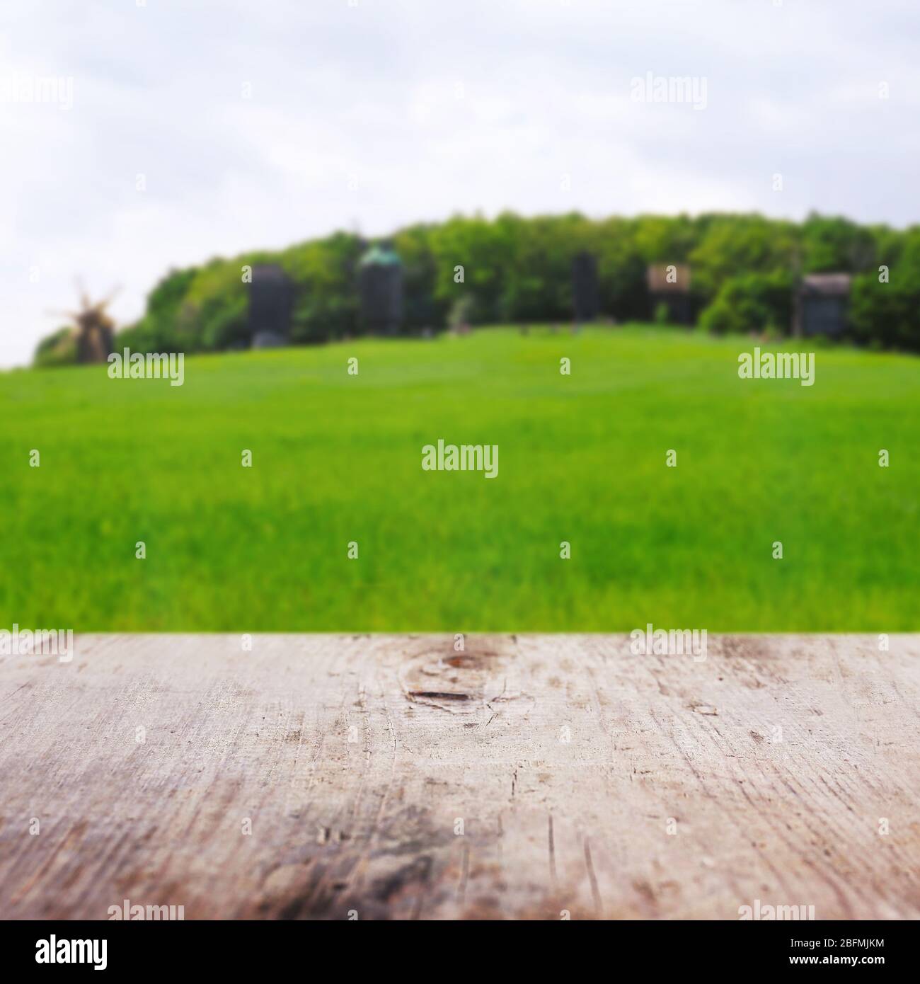 Wooden table on blurred nature background Stock Photo - Alamy