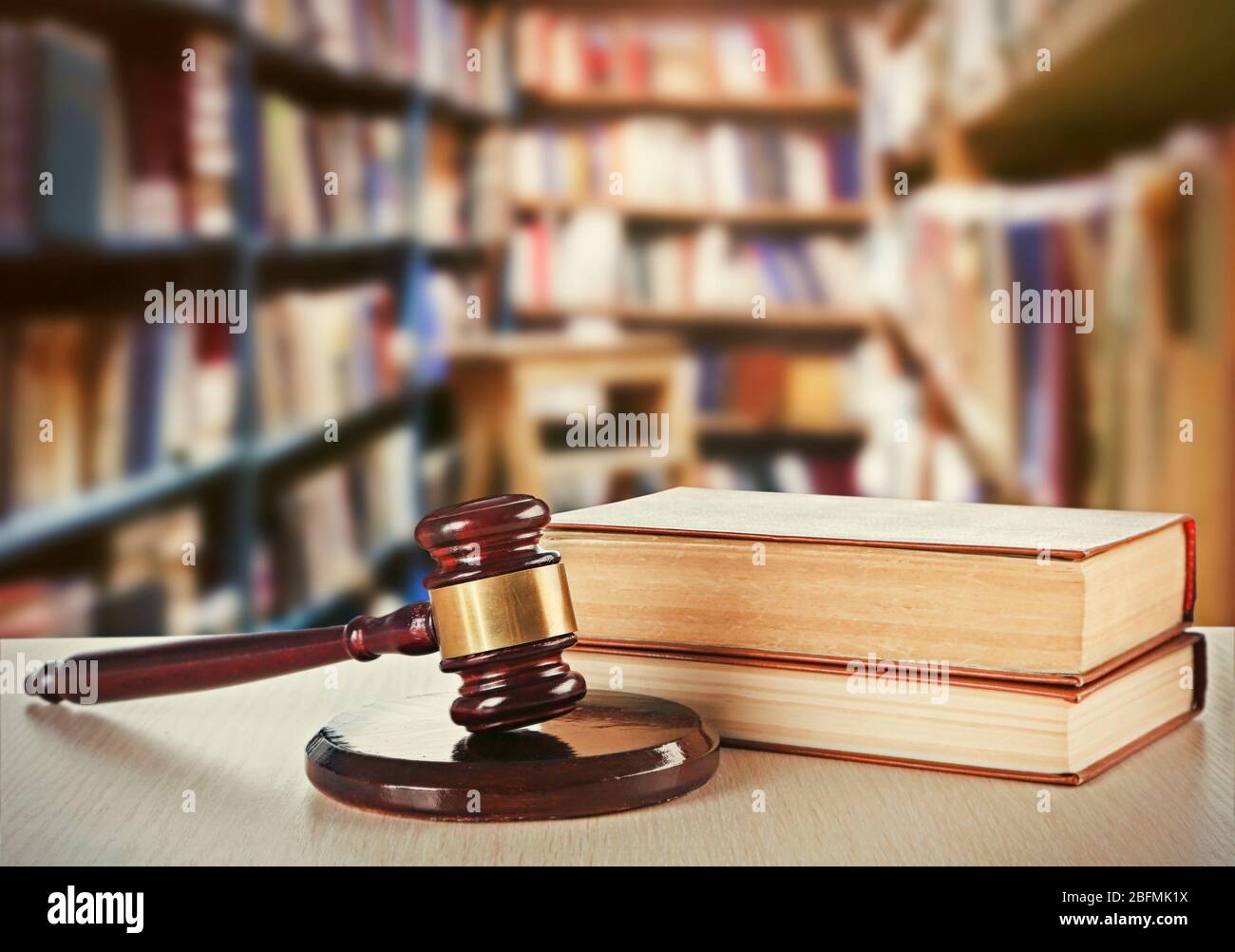 Wooden judges gavel and law books on table in library Stock Photo - Alamy