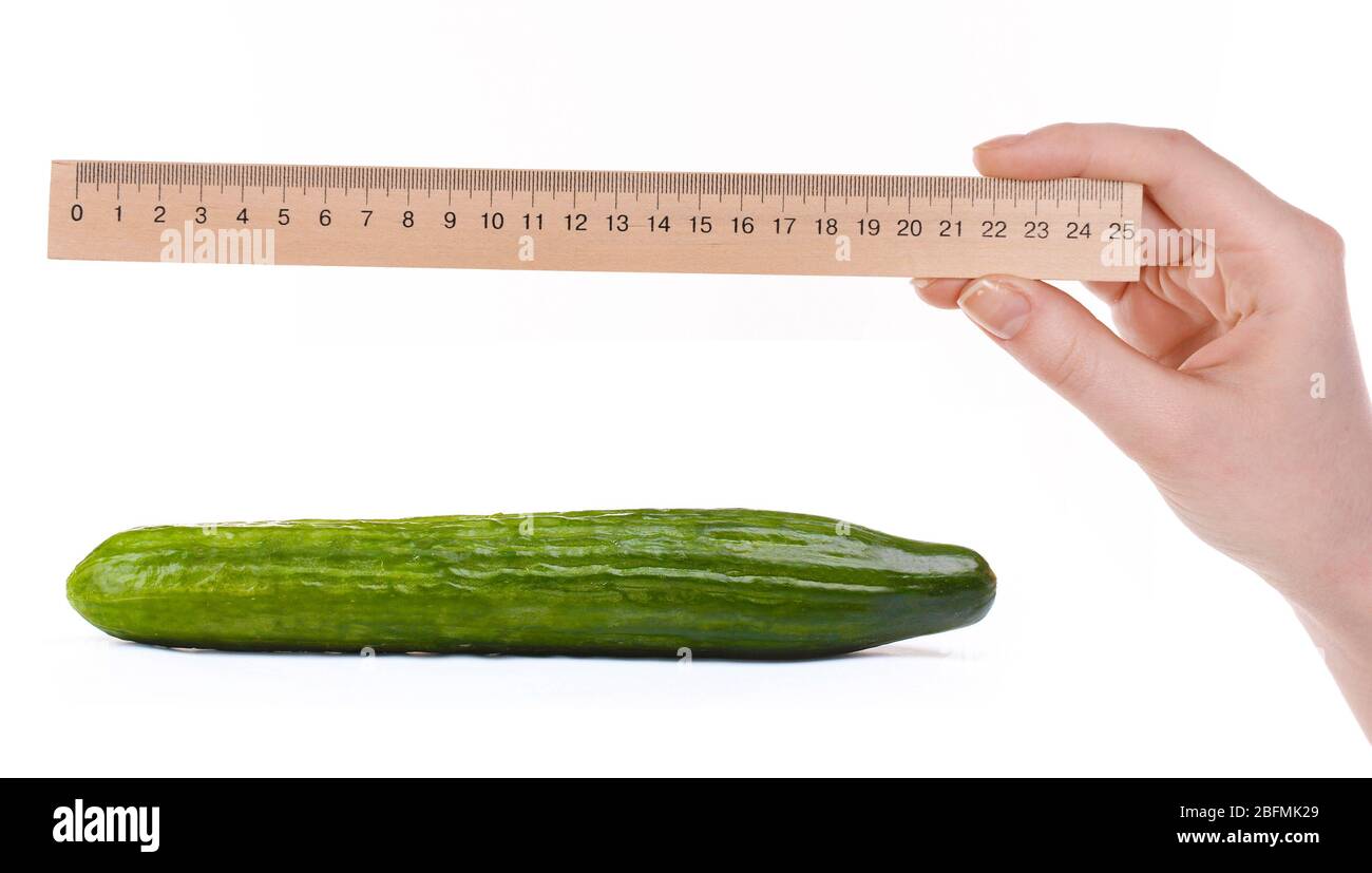 Female hand with ruler and cucumber isolated on white Stock Photo - Alamy