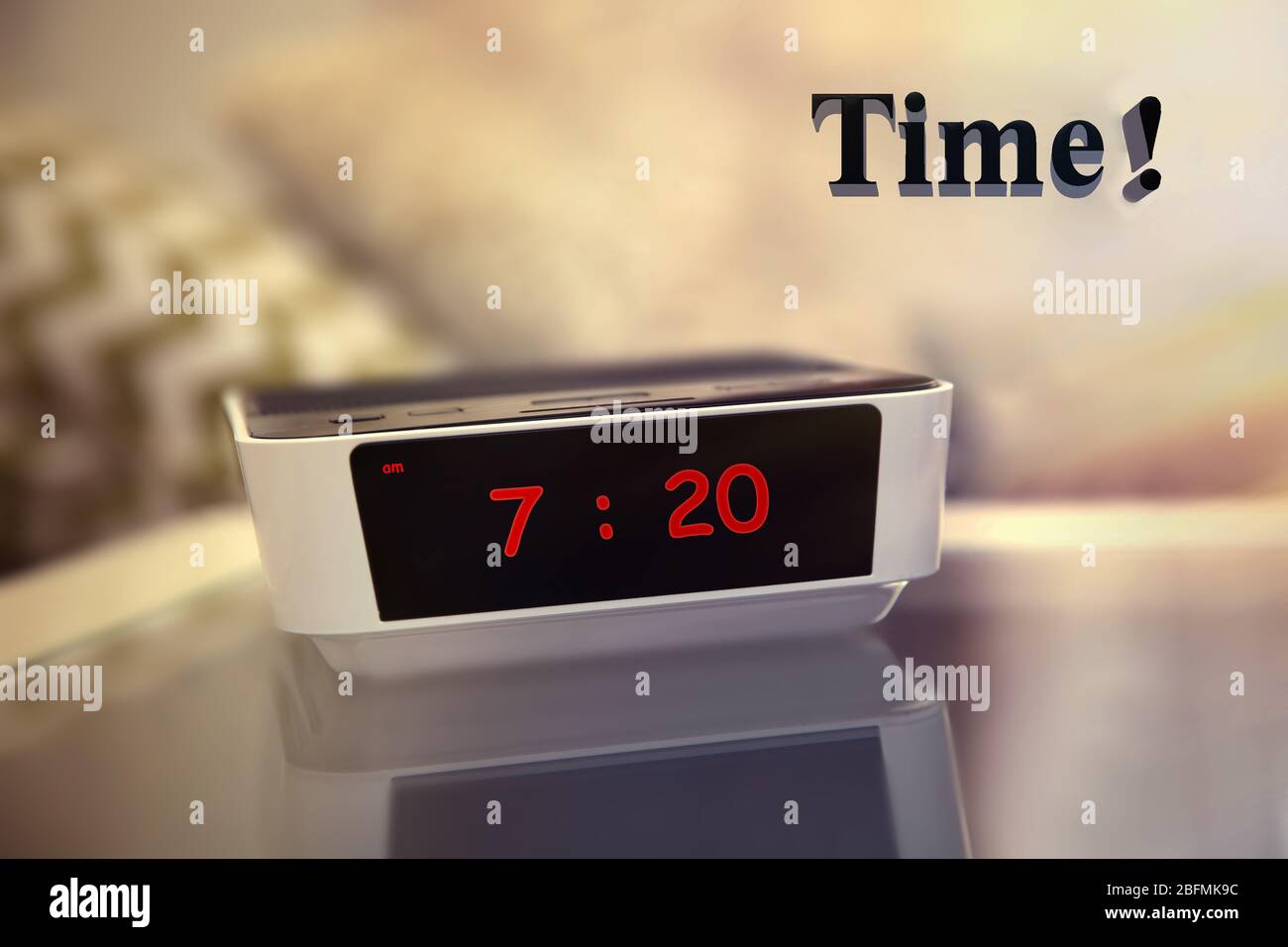 Digital clock showing 7:20 o'clock on a bedside table in bedroom Stock ...