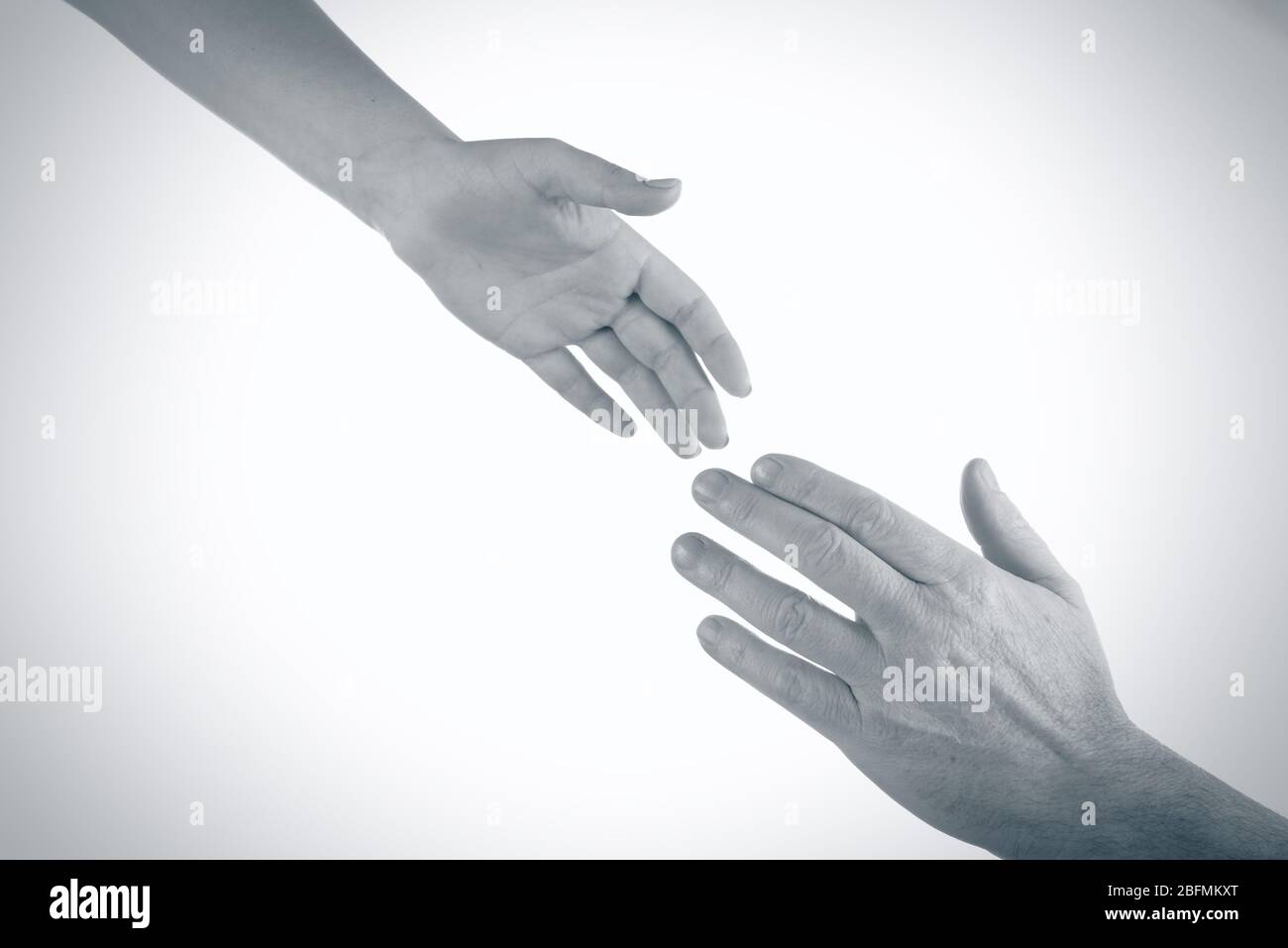 Two hands reaching toward each other. Helping concept. Vintage tone ...