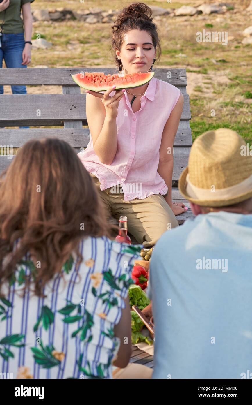 Young attractive Caucasian woman hanging out with friends outdoors ...