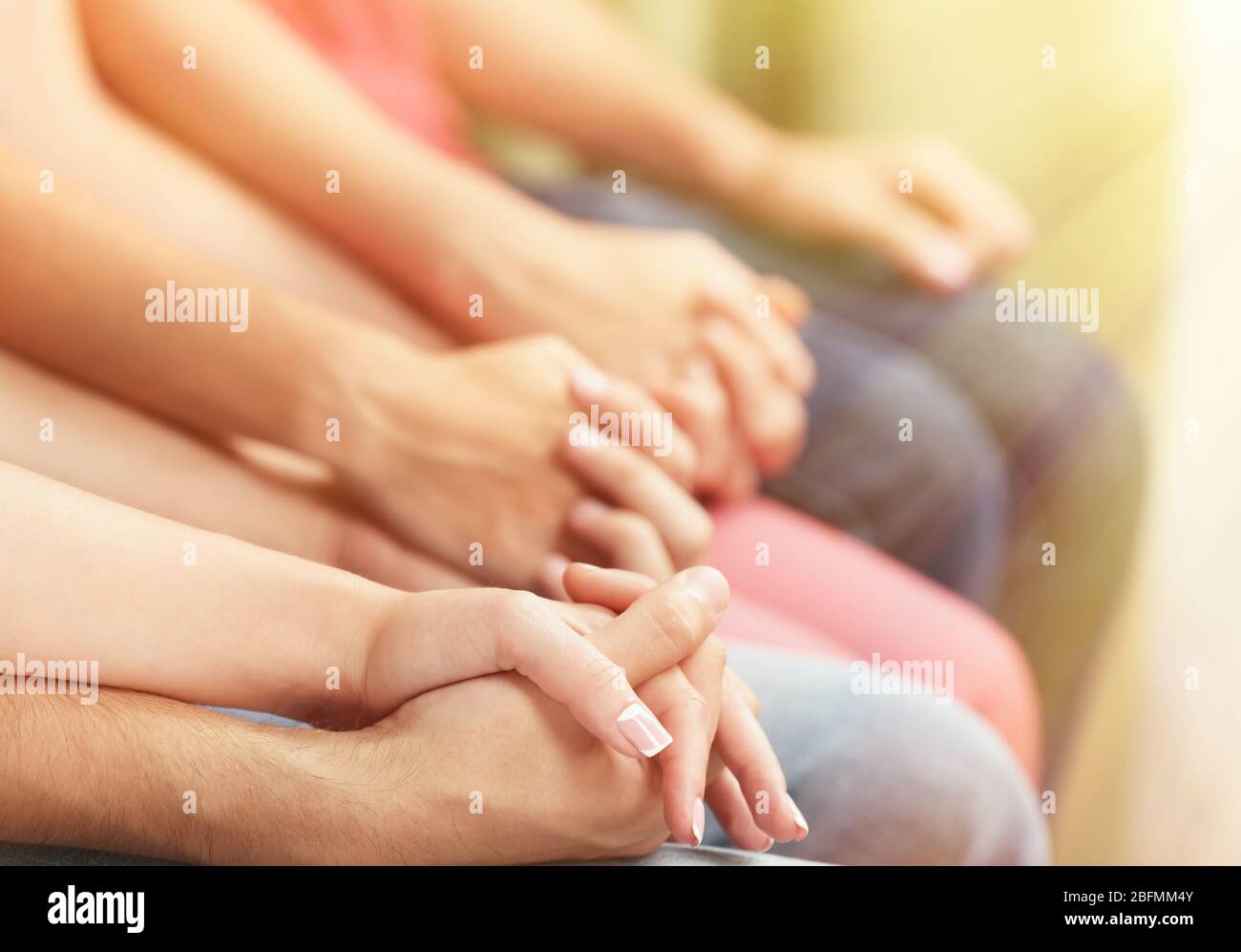 Young people holding hands close up Stock Photo - Alamy