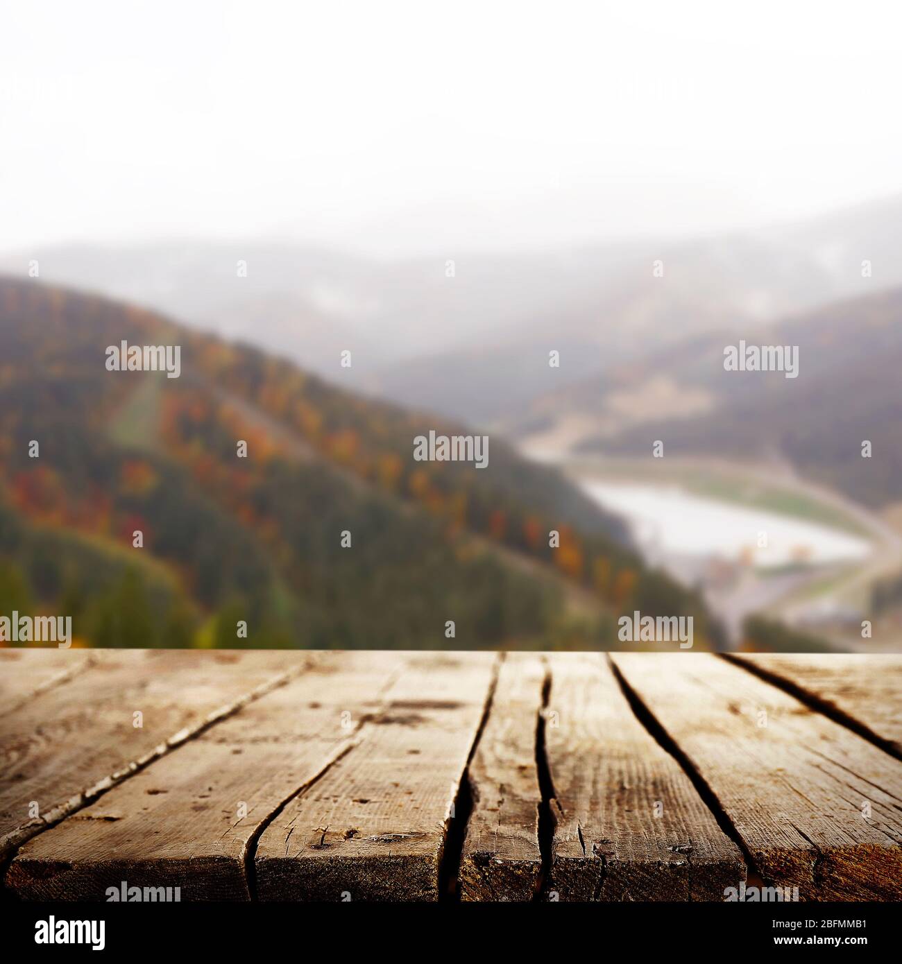 Wooden table on blurred nature background Stock Photo - Alamy