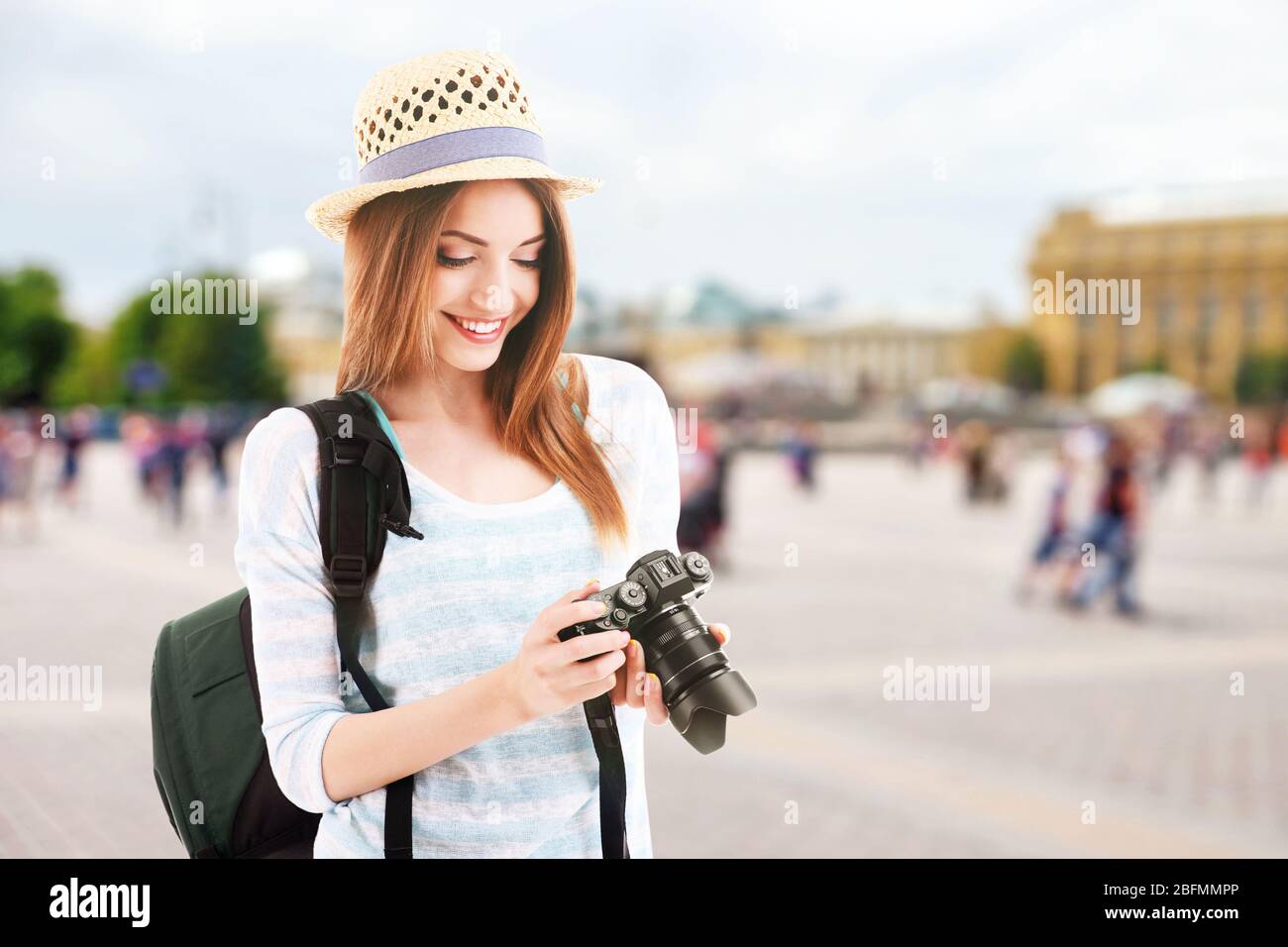 Traveler with camera on city background Stock Photo - Alamy