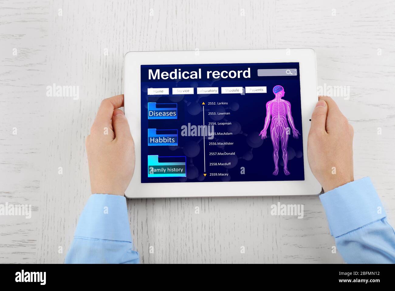 Medical tablet in doctor hands on light background Stock Photo - Alamy
