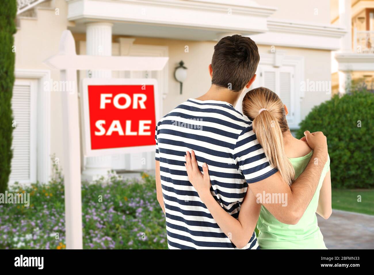 Loving couple looking at their dream house Stock Photo - Alamy