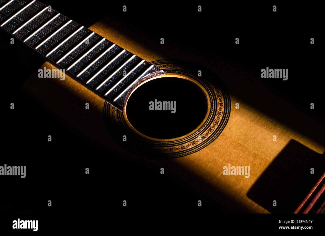 Abstract background of a guitar in the dark. Central part of a guitar ...