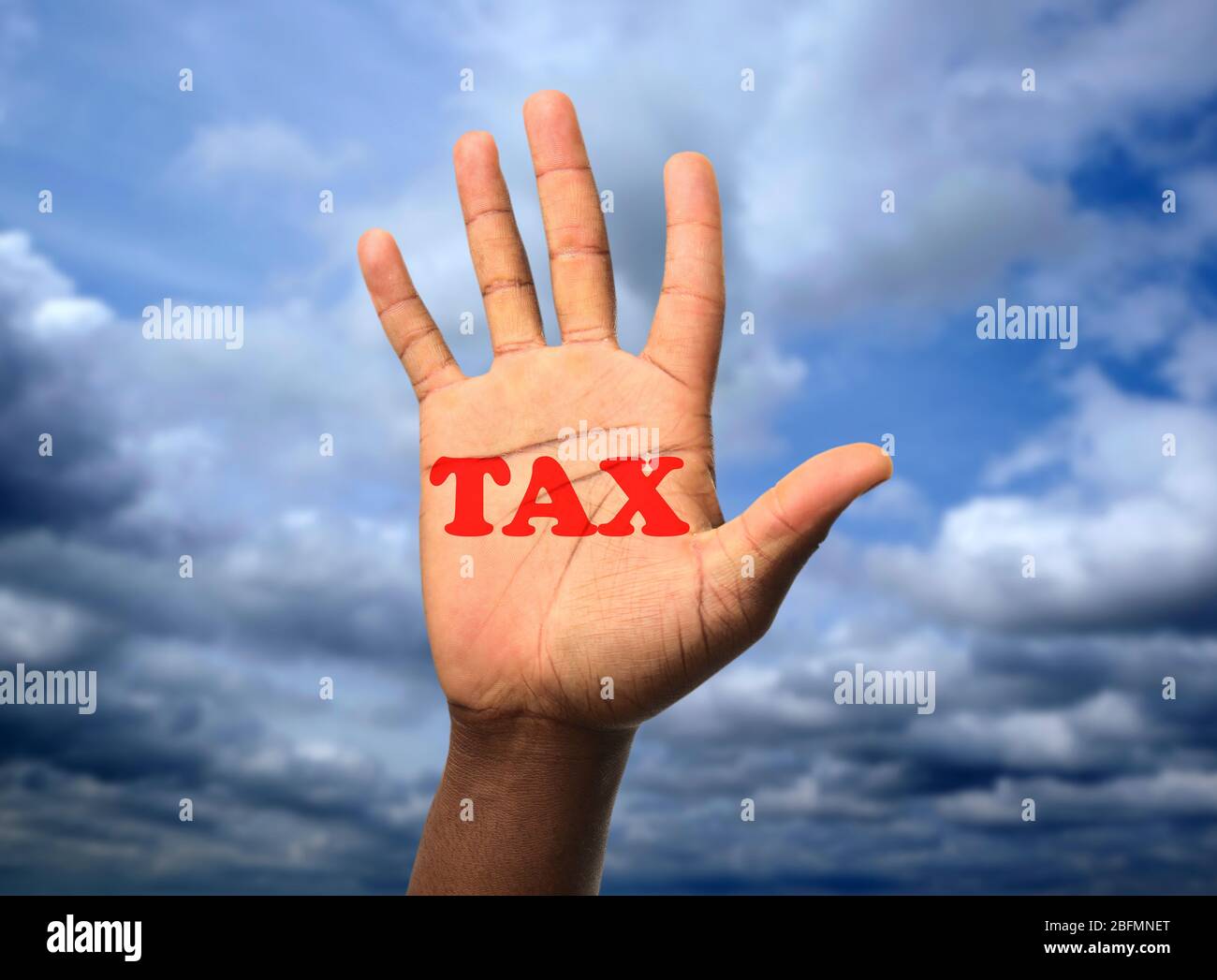Tax concept. Man's hand with Tax sign, on sky background Stock Photo ...