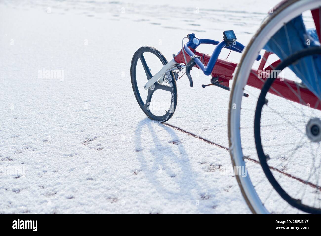 Close-up view of modern racing wheelchair standing outdoors on track ...