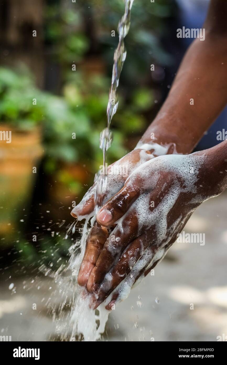Washing hands.Man washing his hands in the garden at home.Coronavirus ...