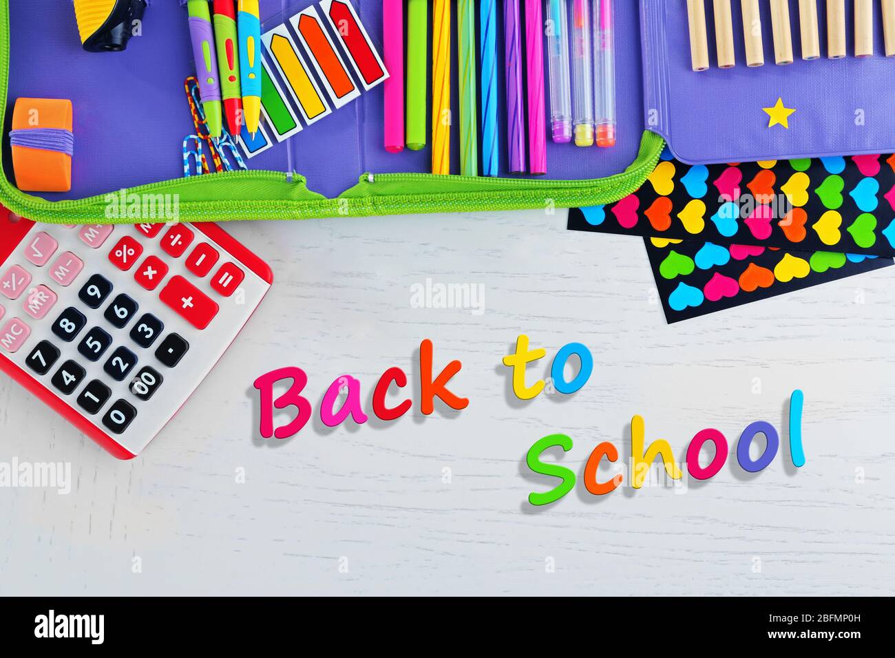 Pencil case with various stationery on wooden table Stock Photo - Alamy