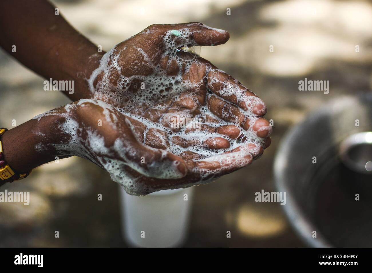 Washing hands.Man washing his hands in the garden at home.Coronavirus ...