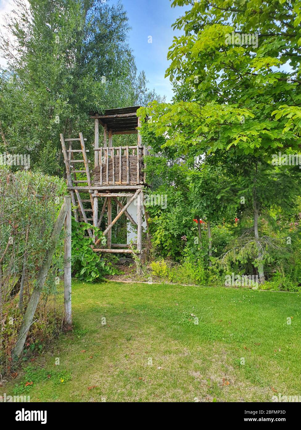 Wood tree house for kids in the garden in summer sunny day Stock Photo ...