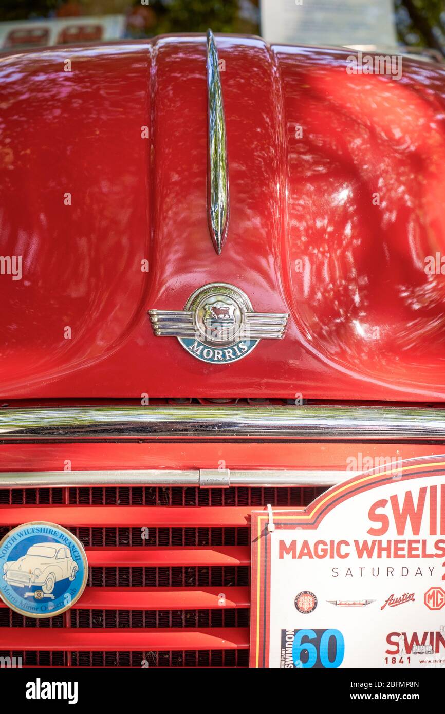 Vintage Morris Minor car badge on red bonnet Stock Photo - Alamy