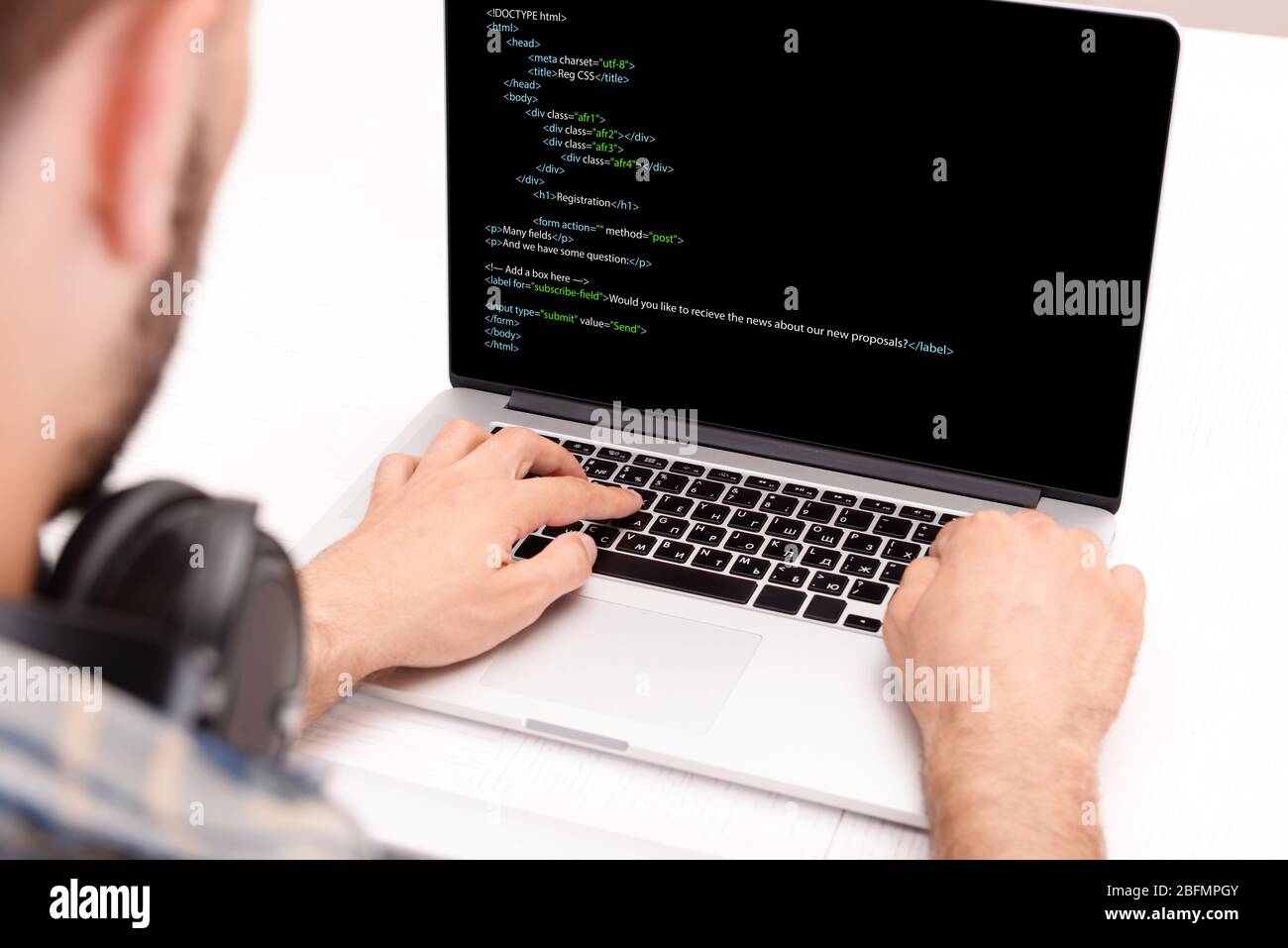 Man using laptop, writing programming code on laptop Stock Photo - Alamy