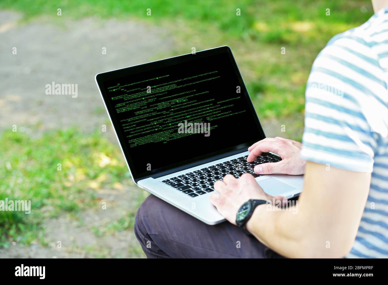 Man using laptop, writing programming code on laptop Stock Photo - Alamy