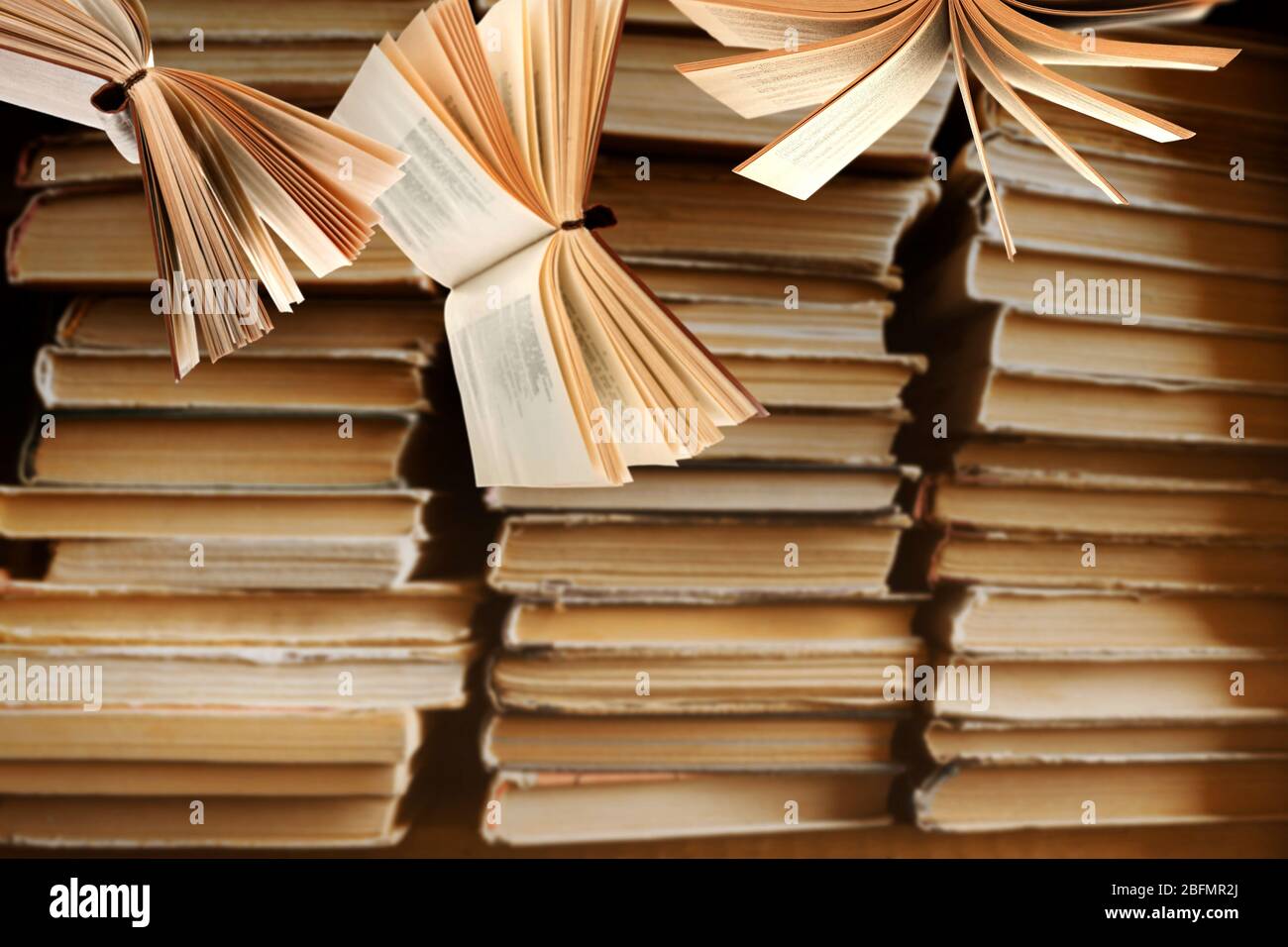 Flying open books in library Stock Photo - Alamy