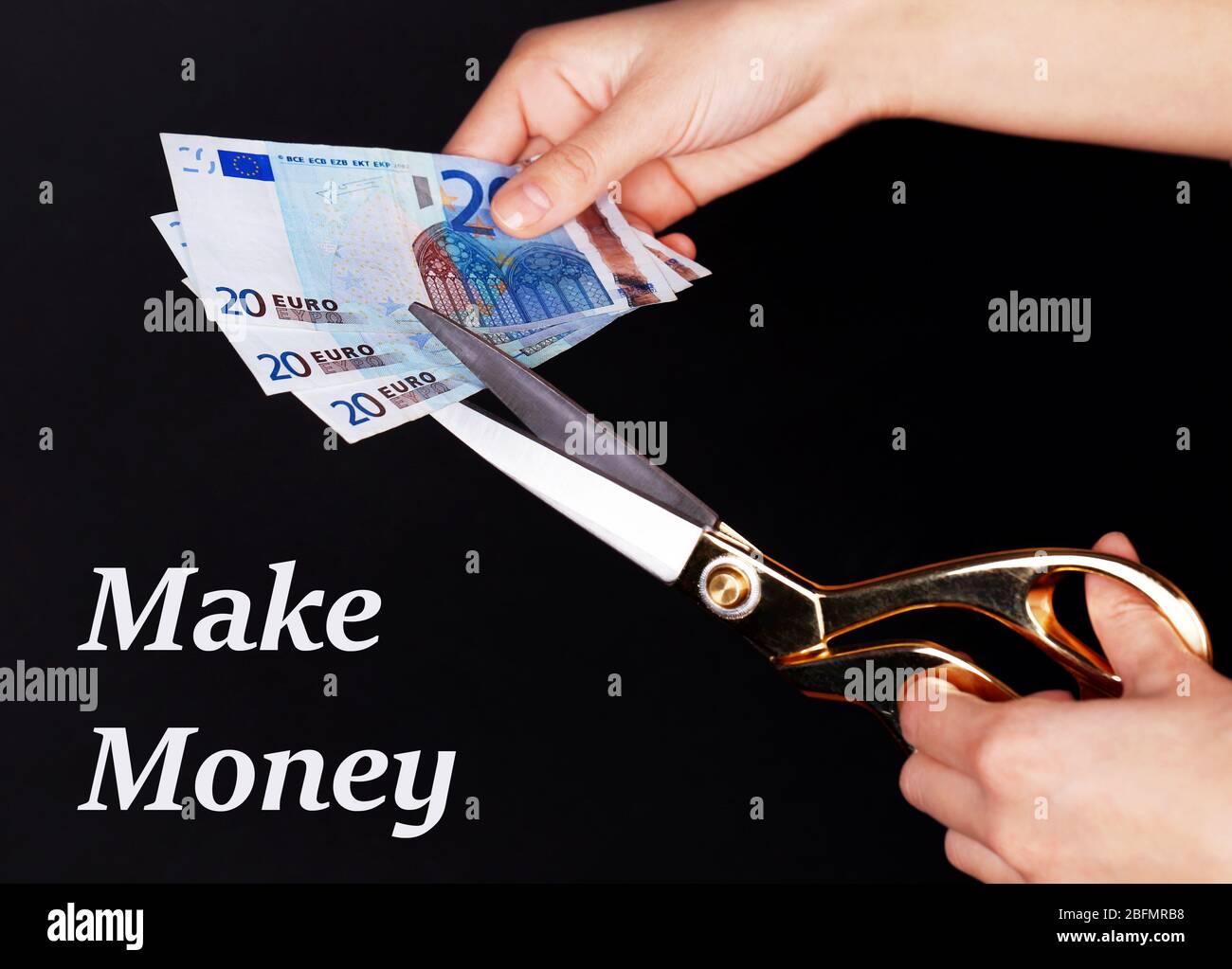 Hands with scissors cutting Euro banknotes, on black background Stock ...
