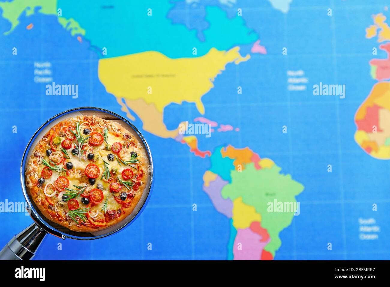 Popular food concept. Looking for pizza on world map Stock Photo - Alamy