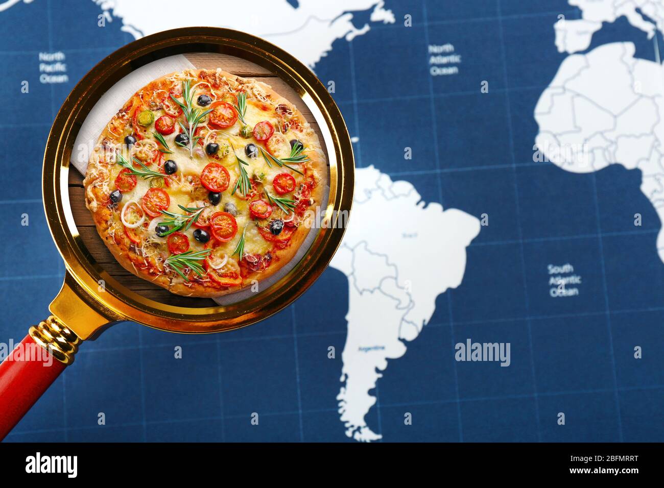 Popular food concept. Looking for pizza on world map Stock Photo - Alamy