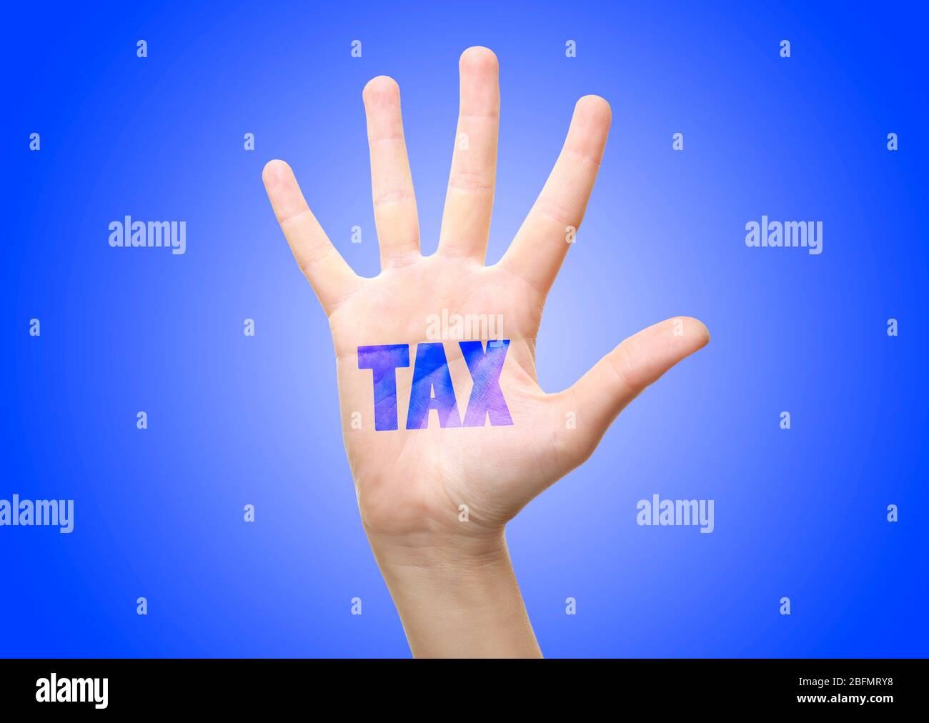 Tax concept. Woman's hand with Tax sign, on blue background Stock Photo ...