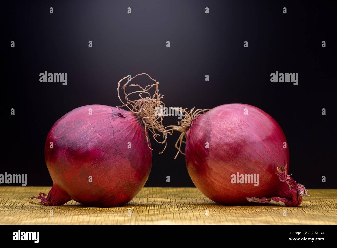 Shiny vibrant purple red onion studio low key still life macro closeup ...