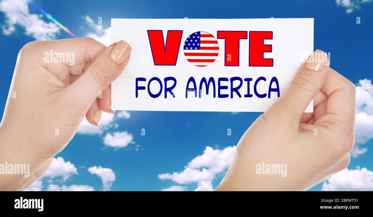 Hands holding Vote for America card on sky background Stock Photo - Alamy