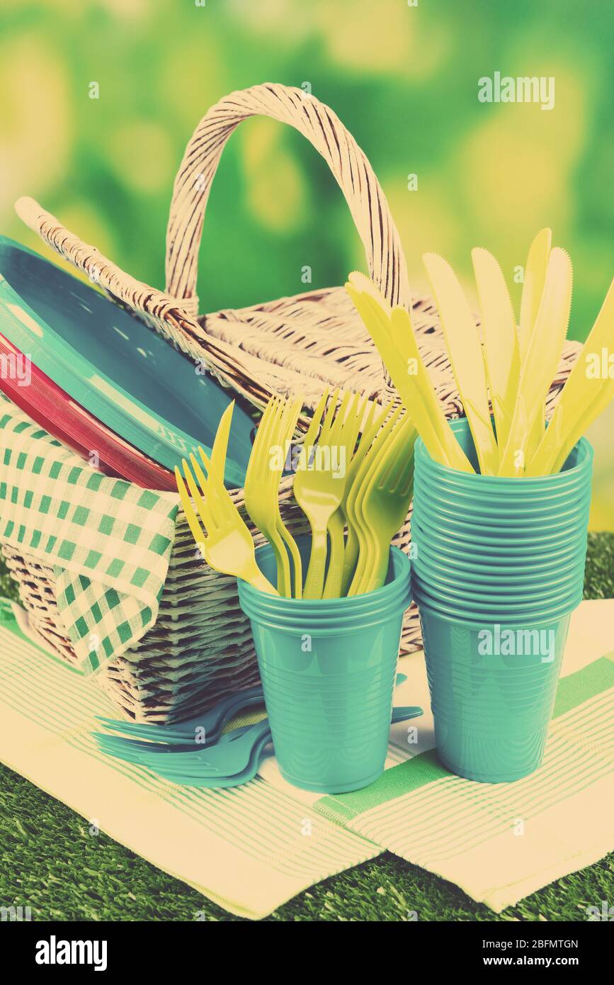 Picnic set with plastic tableware on grass Stock Photo - Alamy