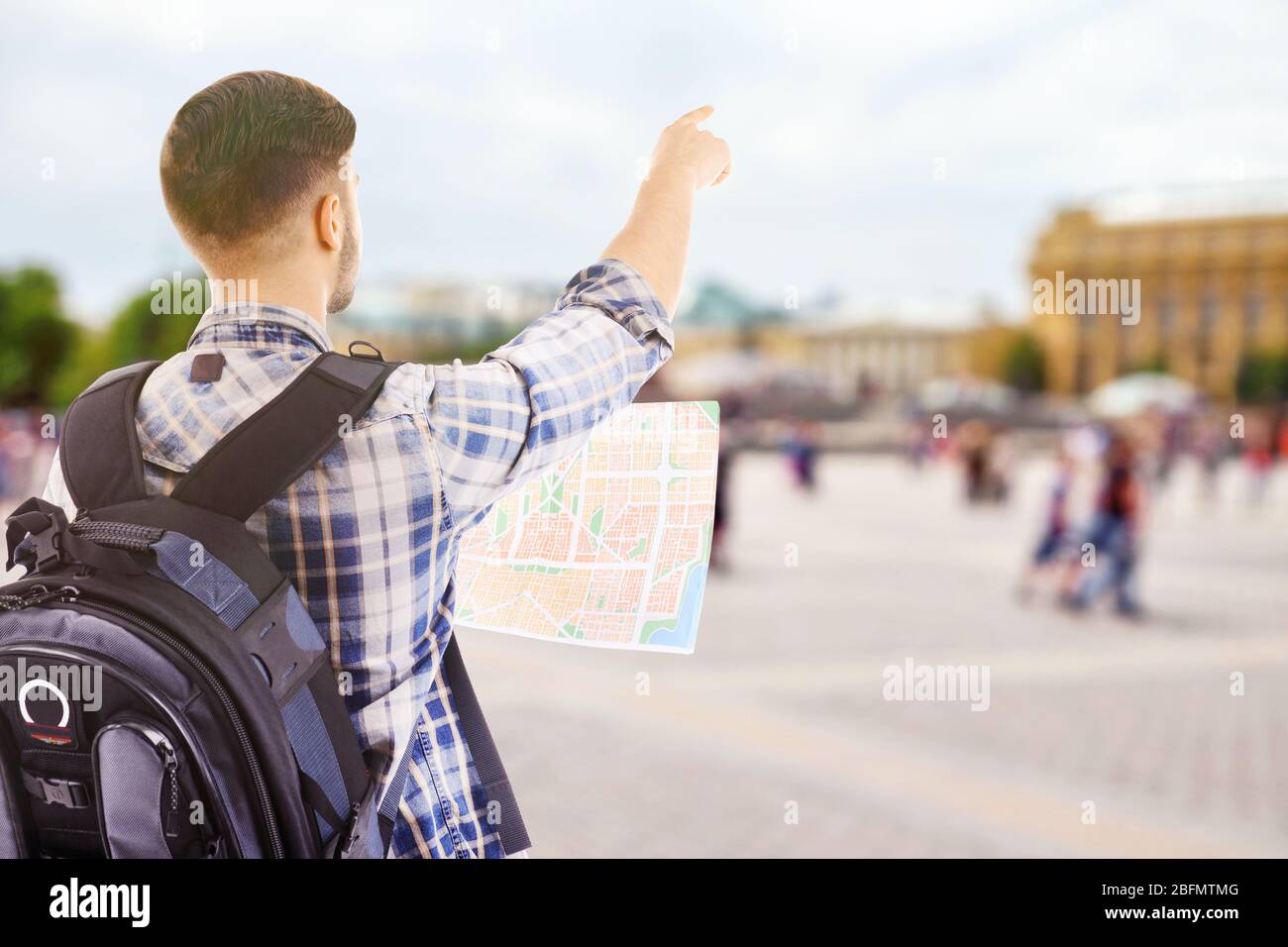 Traveler with map on cityscape background Stock Photo - Alamy