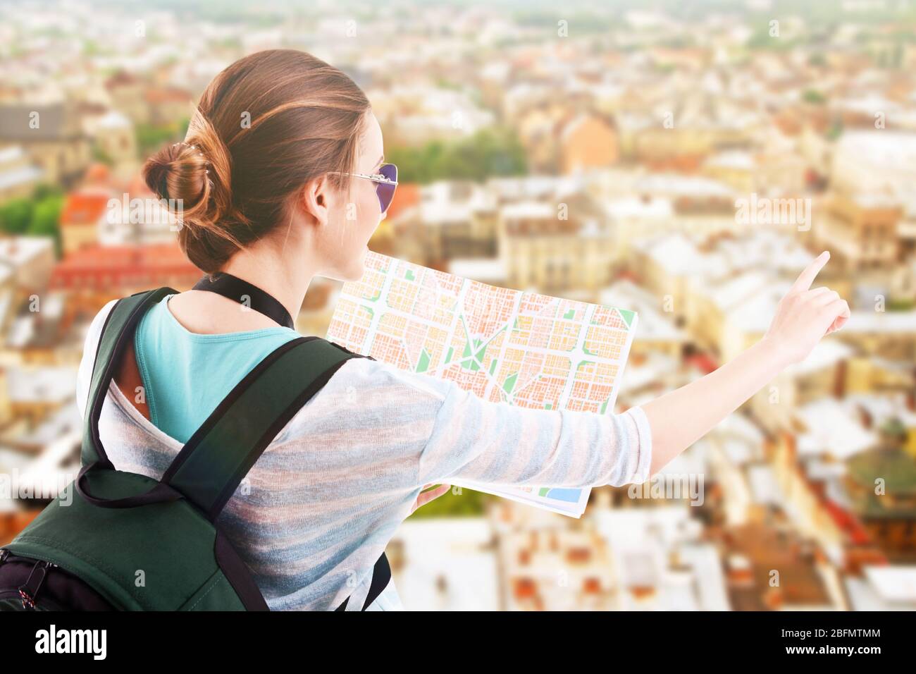 Traveler with map on city background Stock Photo - Alamy