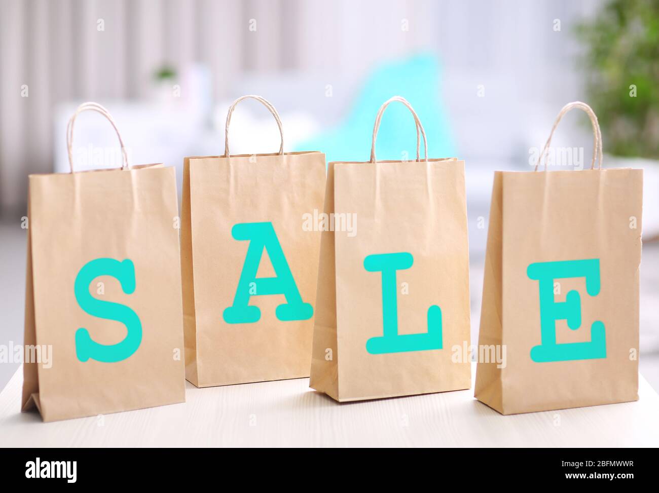 Word sale made with paper bags on blurred background Stock Photo - Alamy