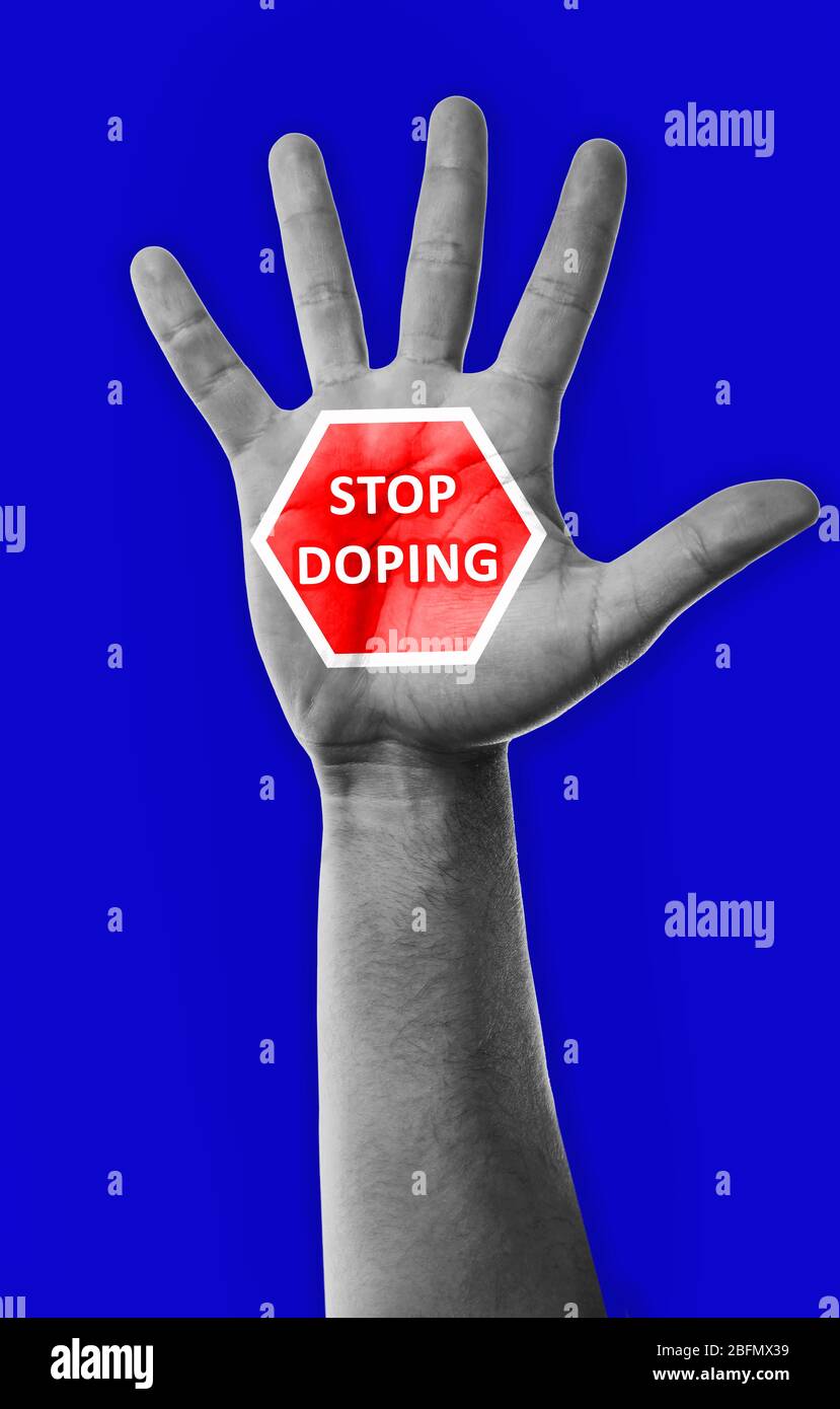 Stop doping concept. Male hand with sign on blue background Stock Photo ...