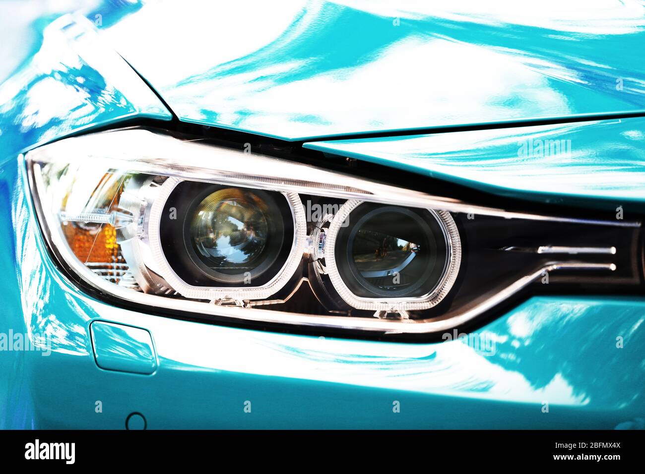 Headlights of blue car Stock Photo - Alamy