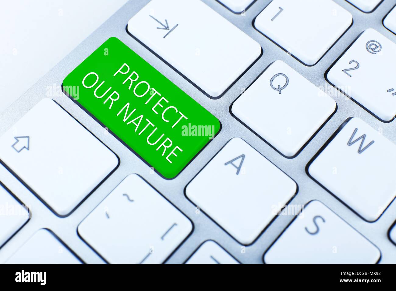 Close-up of laptop keyboard with color button and text Protect Our ...