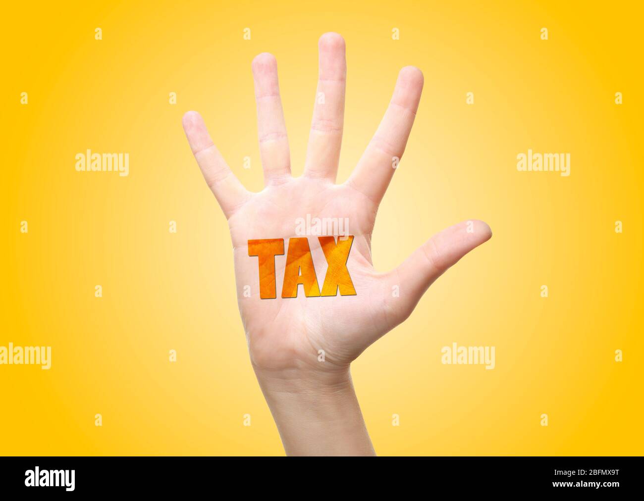 Tax concept. Woman's hand with Tax sign, on yellow background Stock ...
