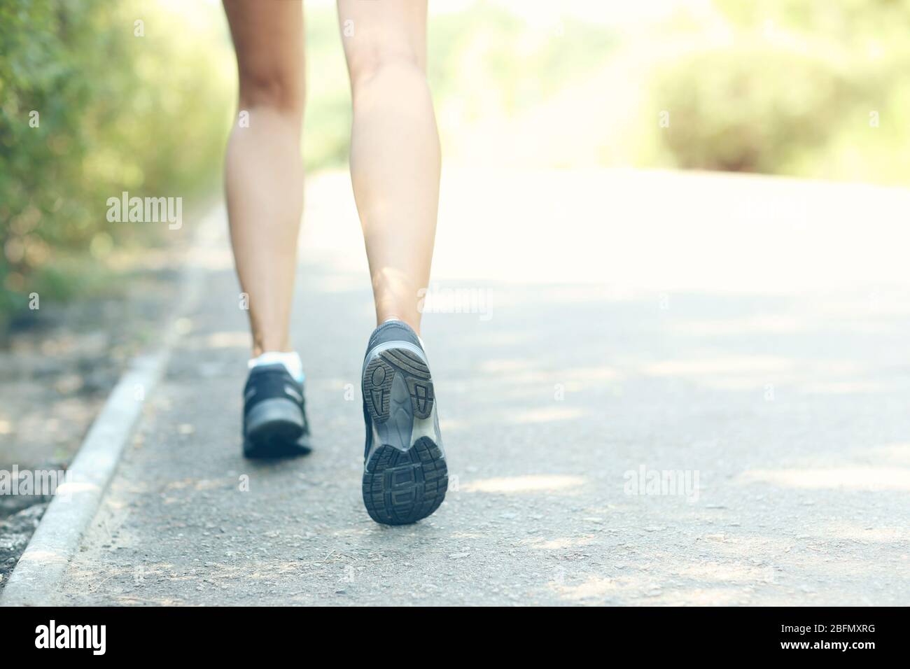 Runner feet on road closeup. Retro style Stock Photo - Alamy