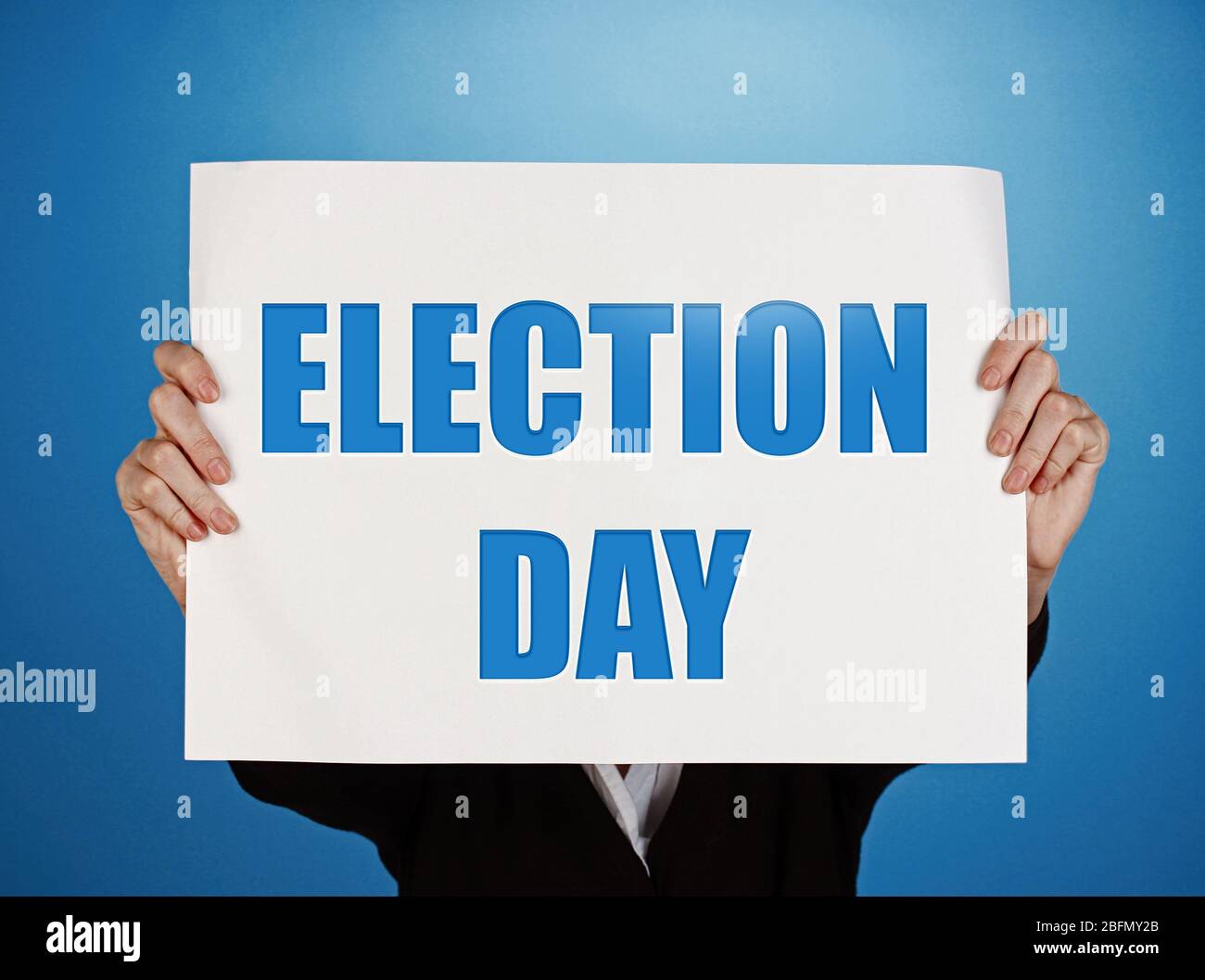 Hands holding card with Election Day text on blue background Stock ...