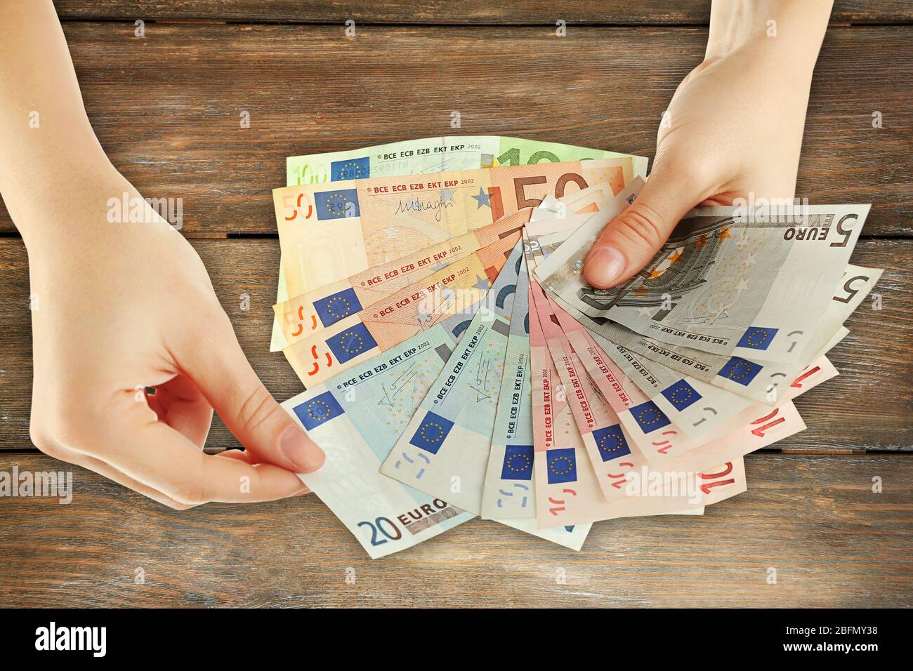Money in female hands Stock Photo - Alamy