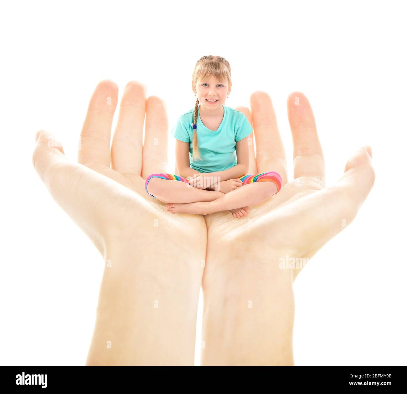 Little girl sitting on hands isolated on white Stock Photo - Alamy
