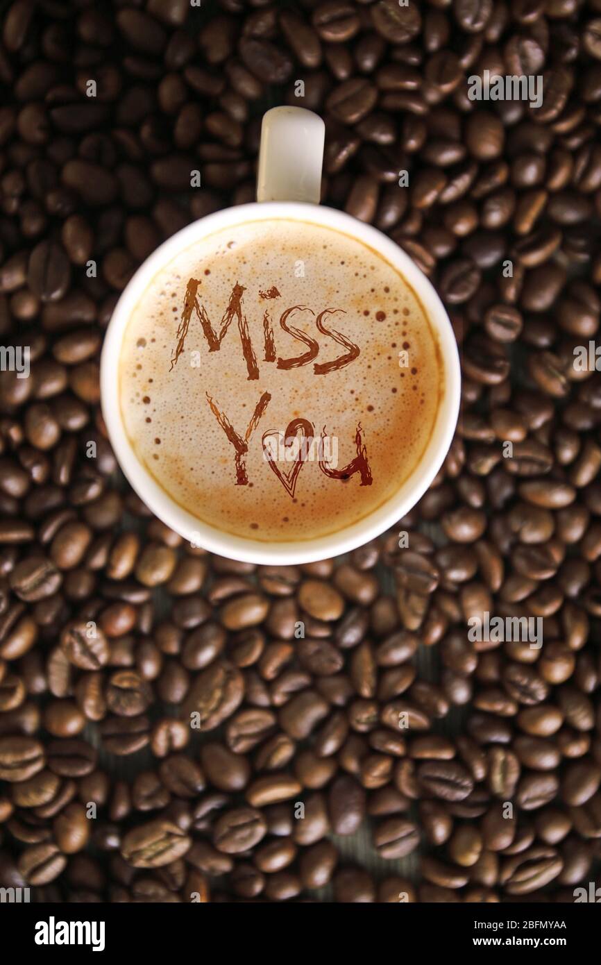 Cup of coffee with words Miss You on foam, top view Stock Photo - Alamy