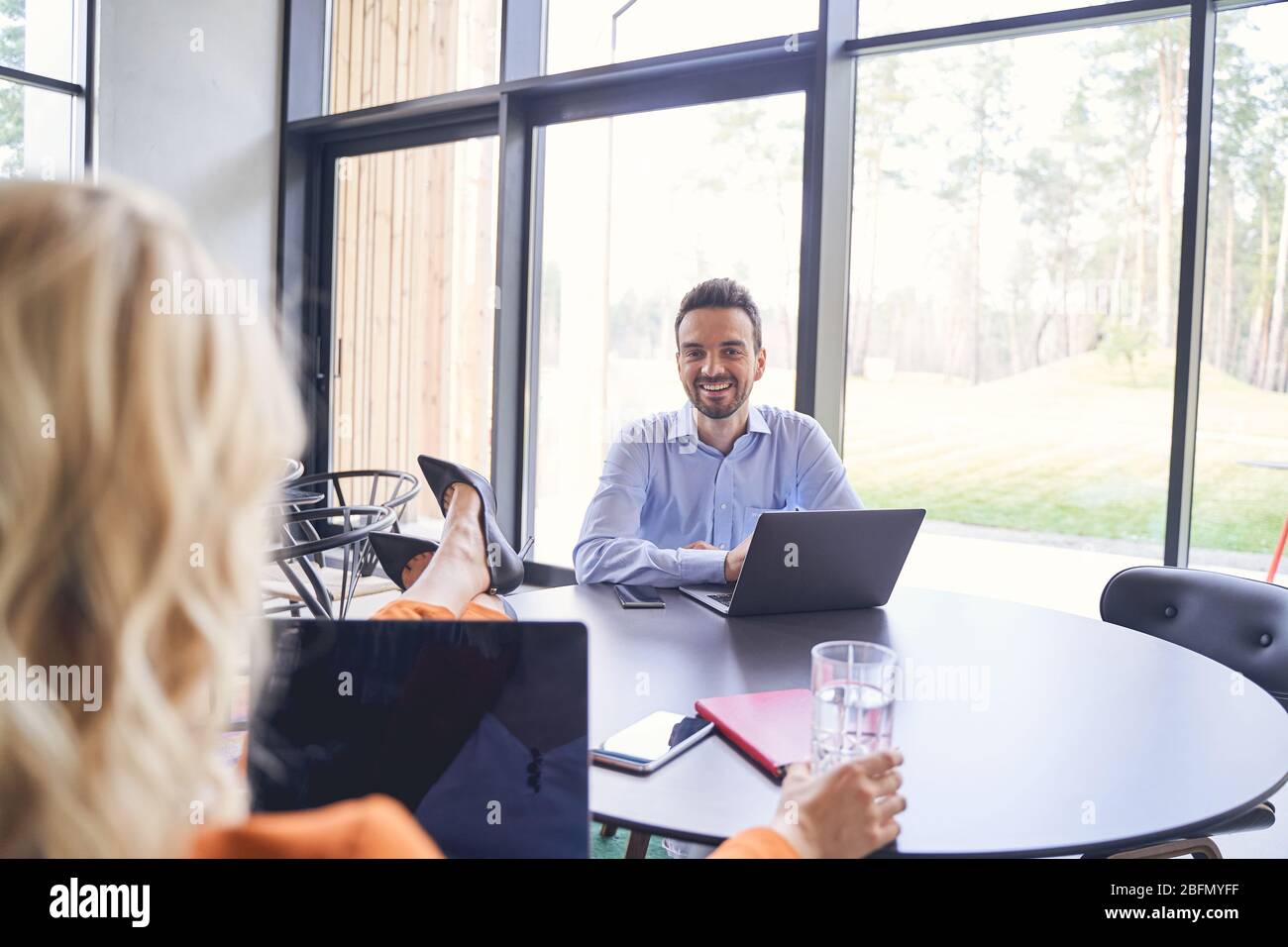 Two business people talking at the table Stock Photo - Alamy