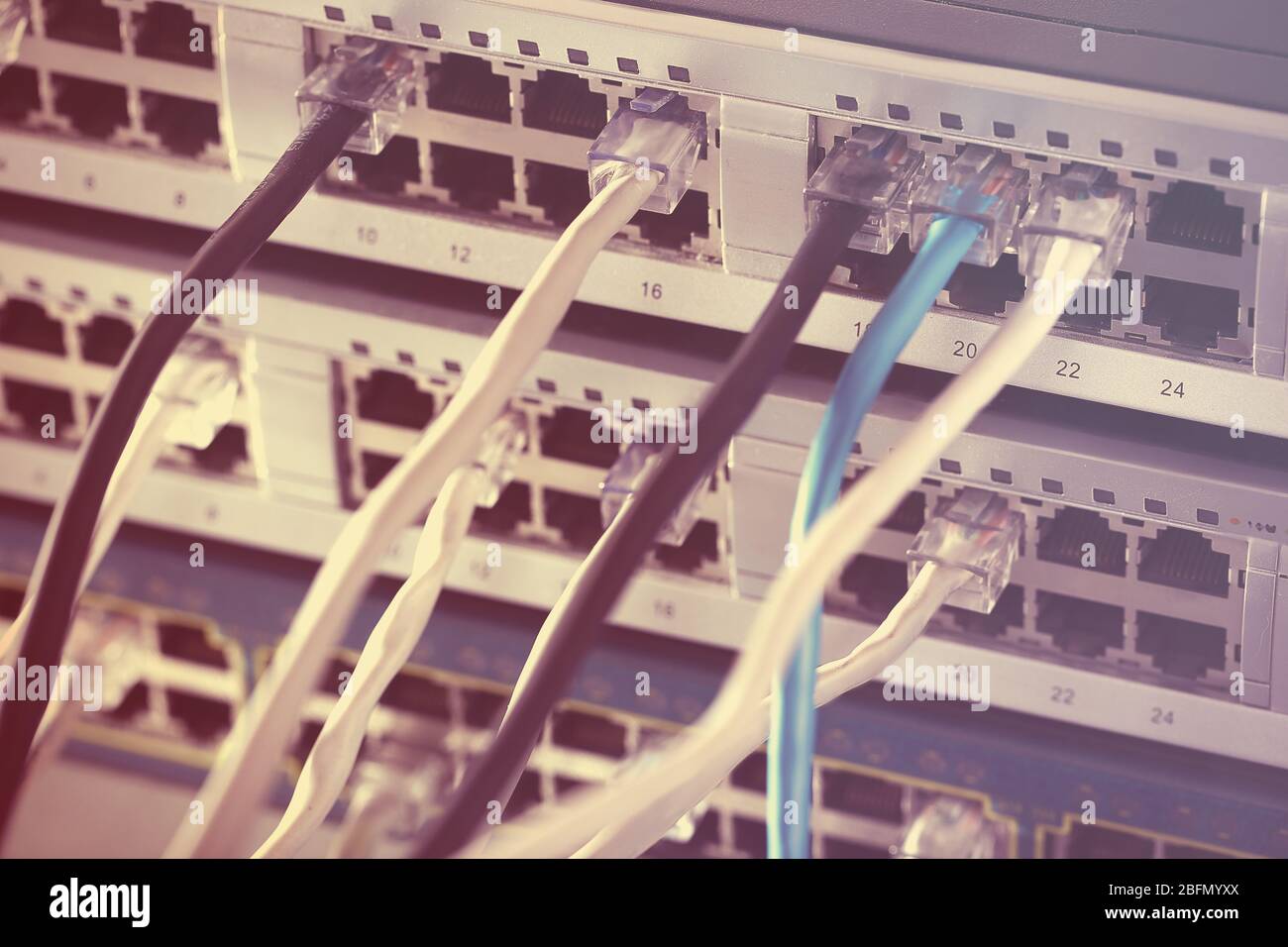 Telecommunication ethernet cables connected to Internet switch. Data center concept Stock Photo ...
