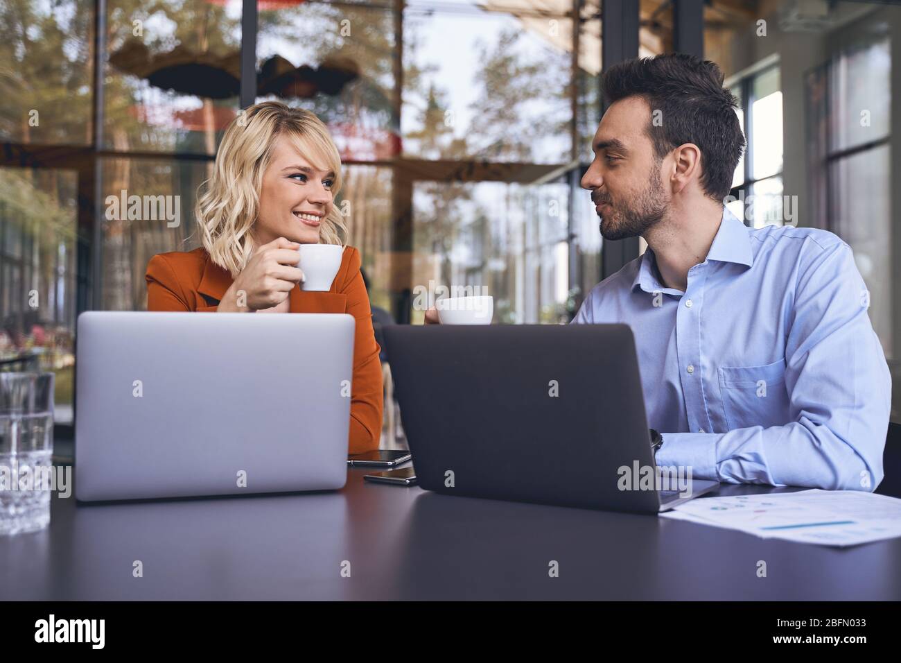 Two business people taking a coffee break Stock Photo - Alamy
