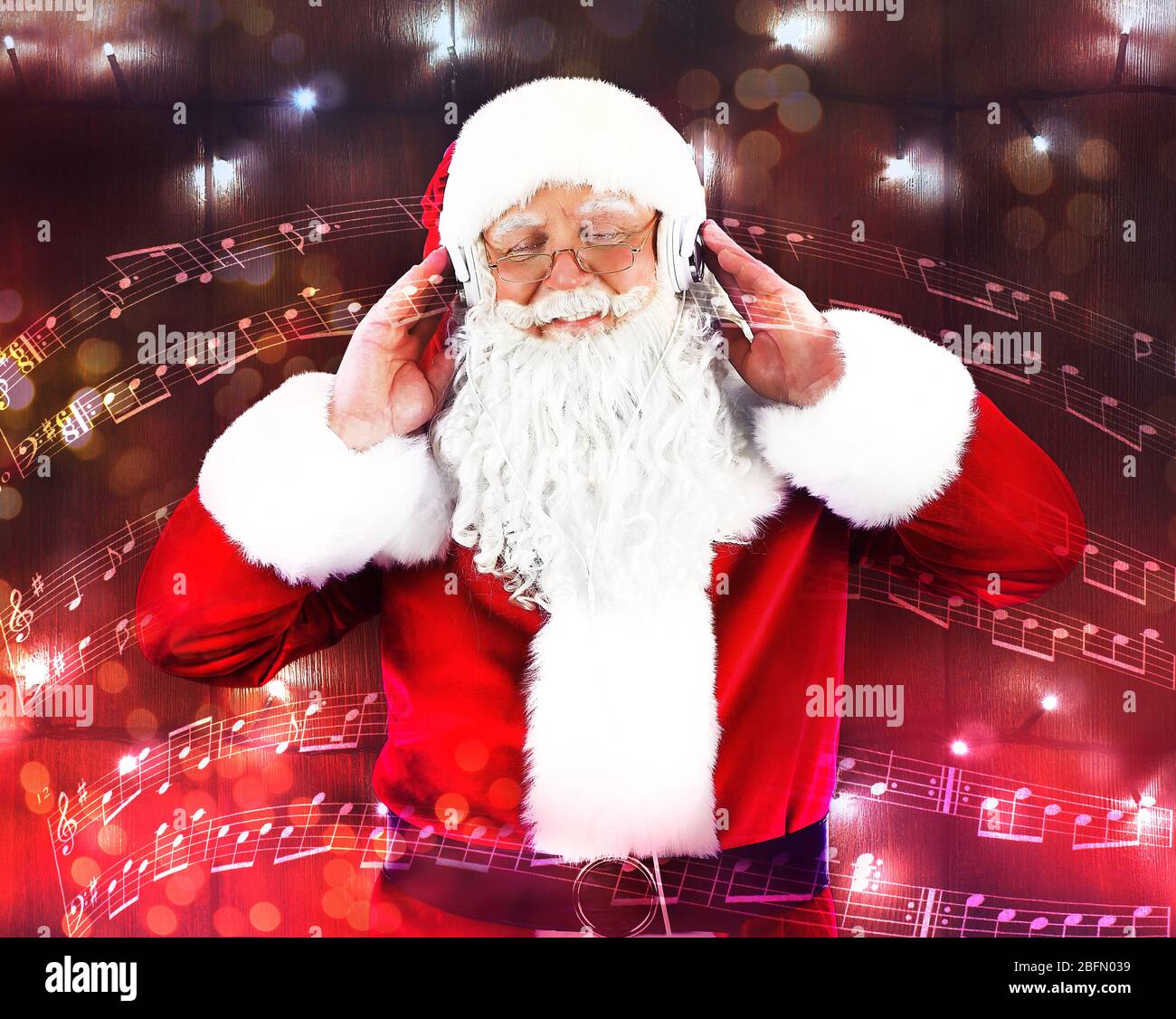 Santa Claus with headphones against musical background Stock Photo - Alamy