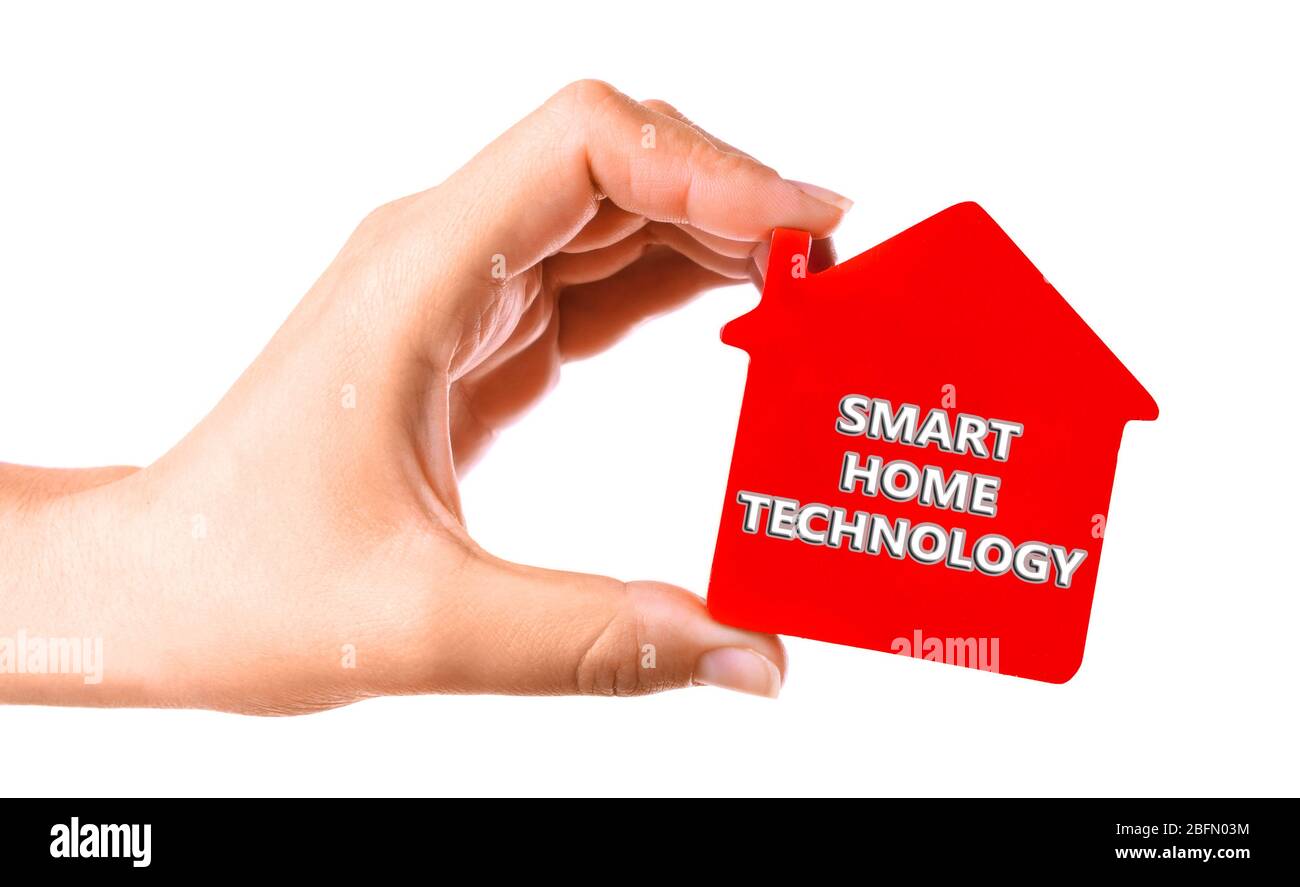 Smart home technology concept. Female hand with small model of house ...