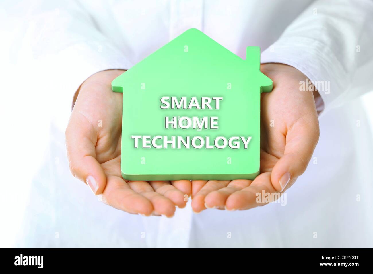 Smart home technology concept. Female hands holding house, closeup ...