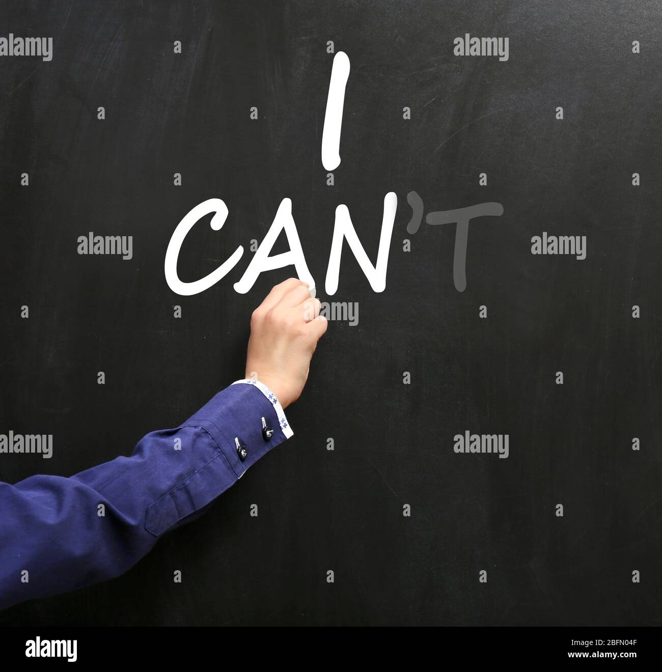 Hand writing words I cant transformed into I can on blackboard Stock ...